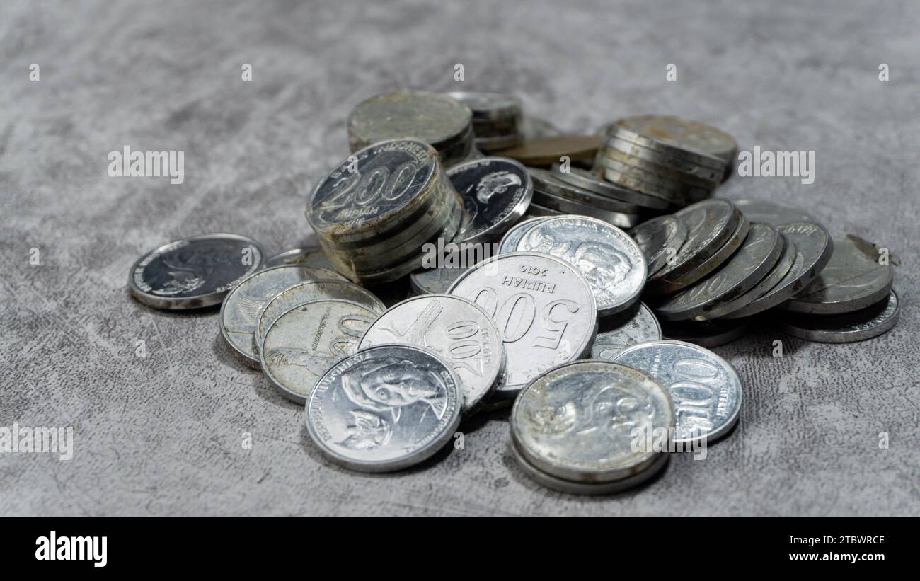 Stack of Indonesian Rupiah currency coins on a gray background with ...