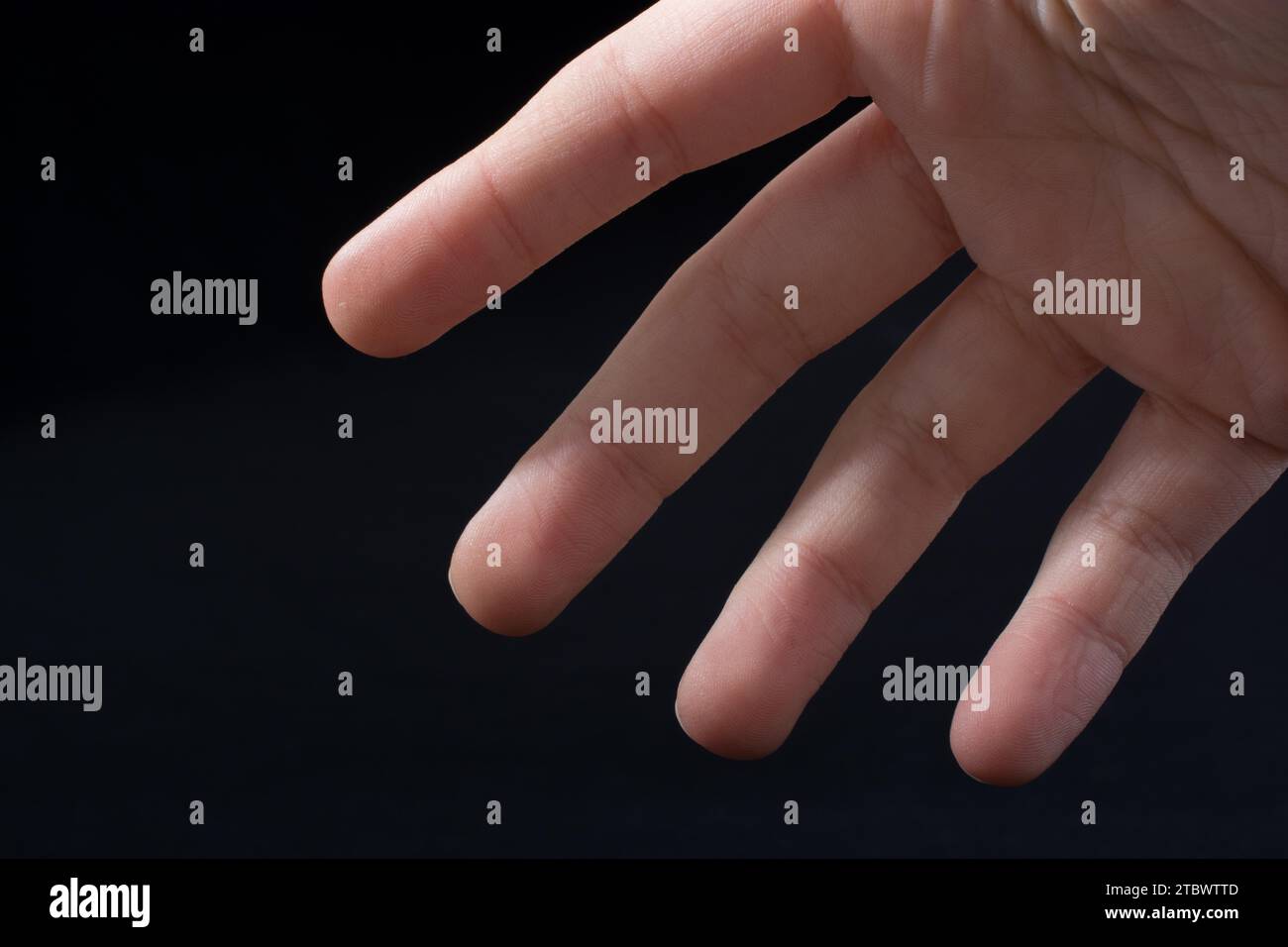 Four fingers of a child hand partly seen in black background Stock ...