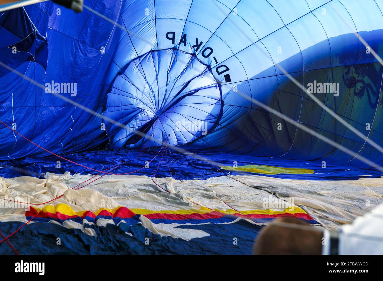 View into the interior of a blue hot-air balloon, lying on the ground ...
