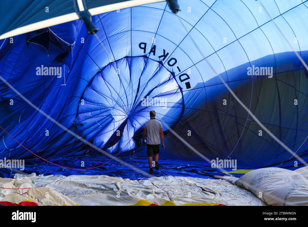 View into the interior of a blue hot air balloon, lying on the ground ...