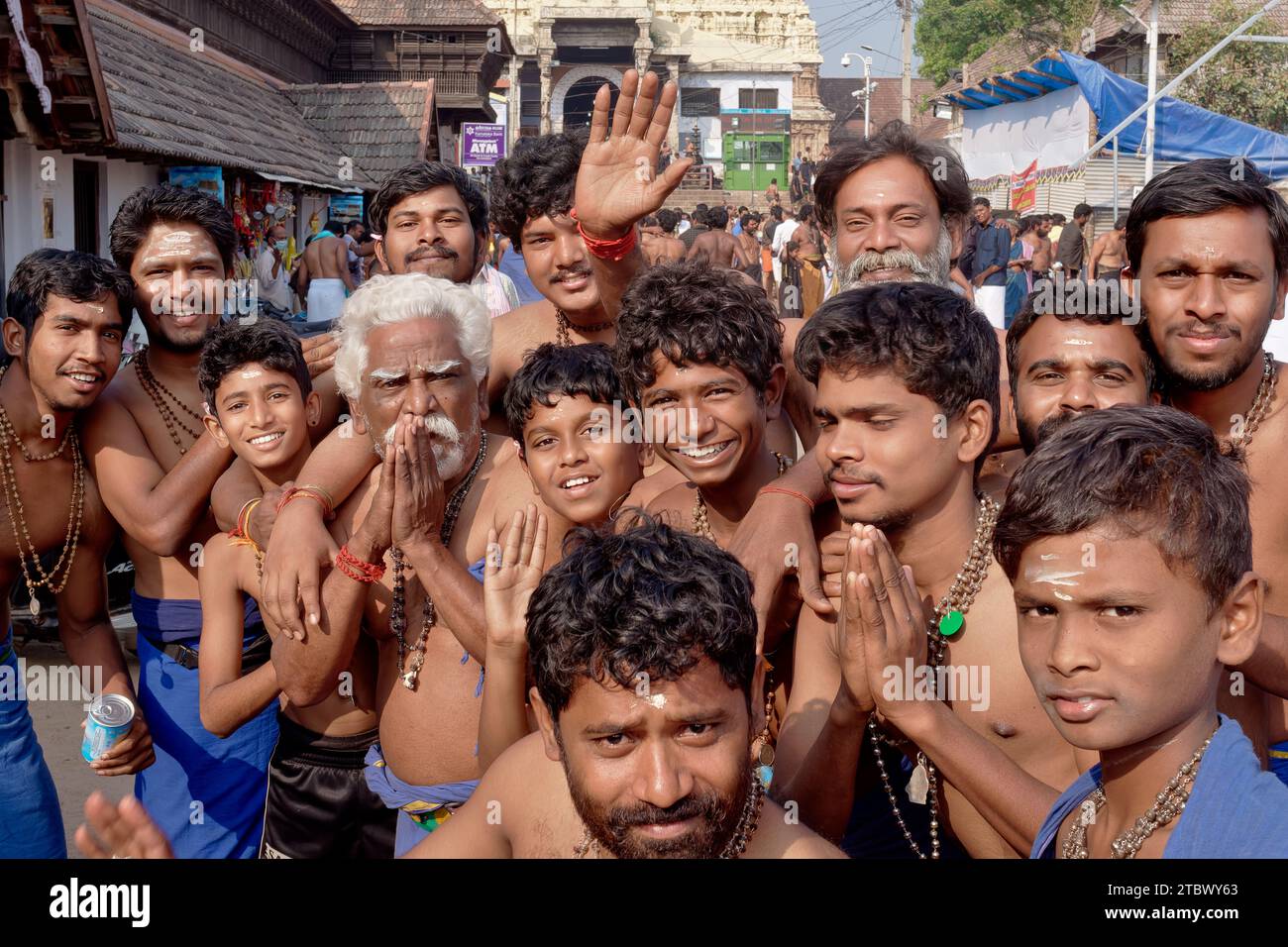 A group of all-male, cheerful and excited Hindu pilgrims posing in ...
