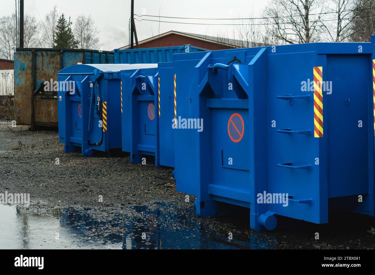 Large blue waste containers on gravel Stock Photo - Alamy