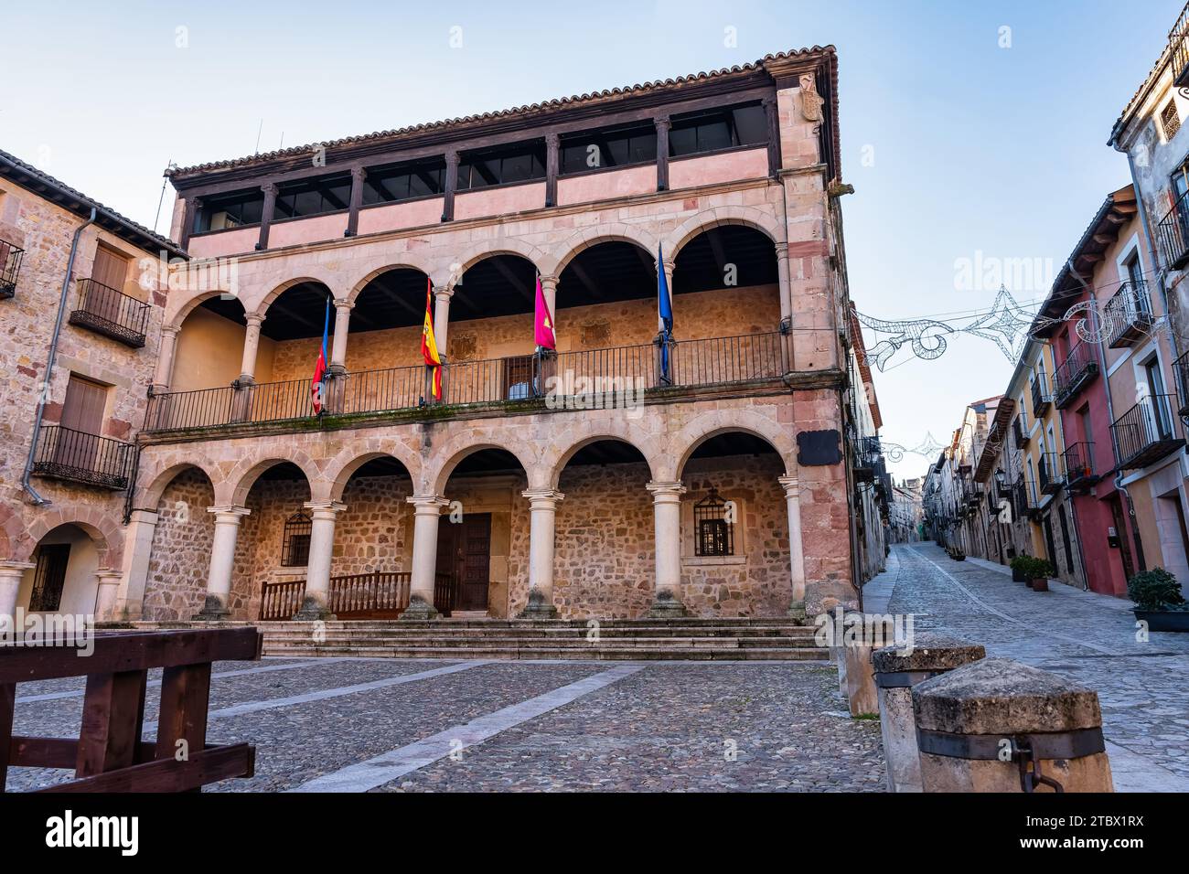 Portico with stone arches and columns in the main square of the ...