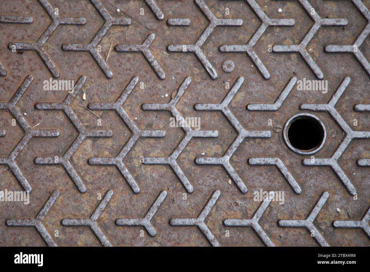 background brown sewer plate cast rusty iron steel on sidewalk of the ...
