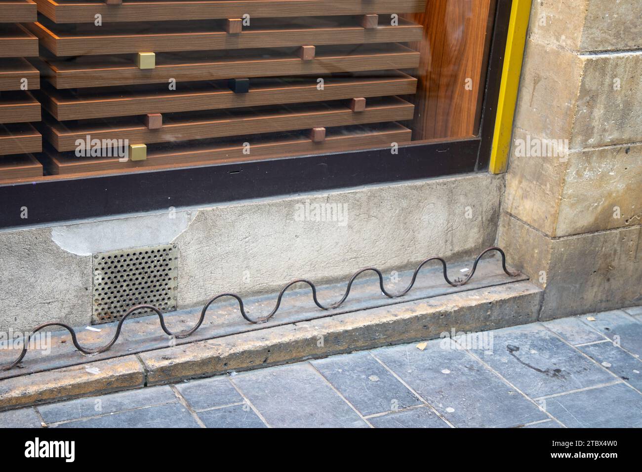 hostile design steel mounted on store facade prevents the homeless ...