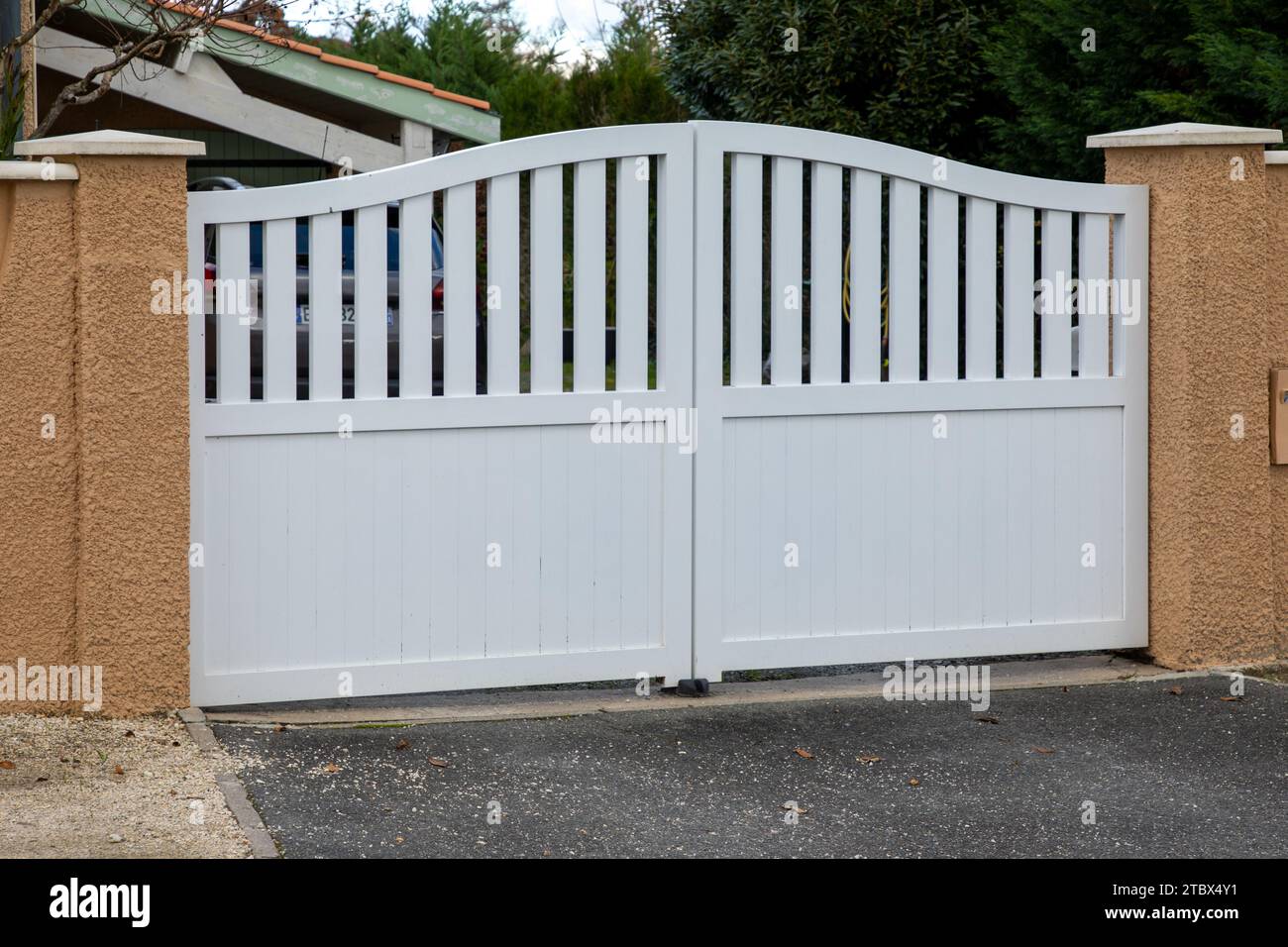 Aluminum white round metal double gate of suburb house Stock Photo - Alamy