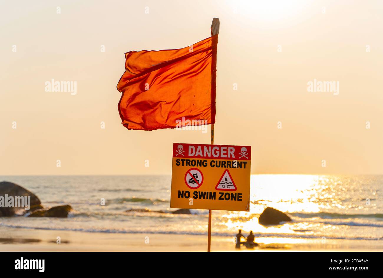 No swimming sign with red flag on the beach of Goa Stock Photo - Alamy