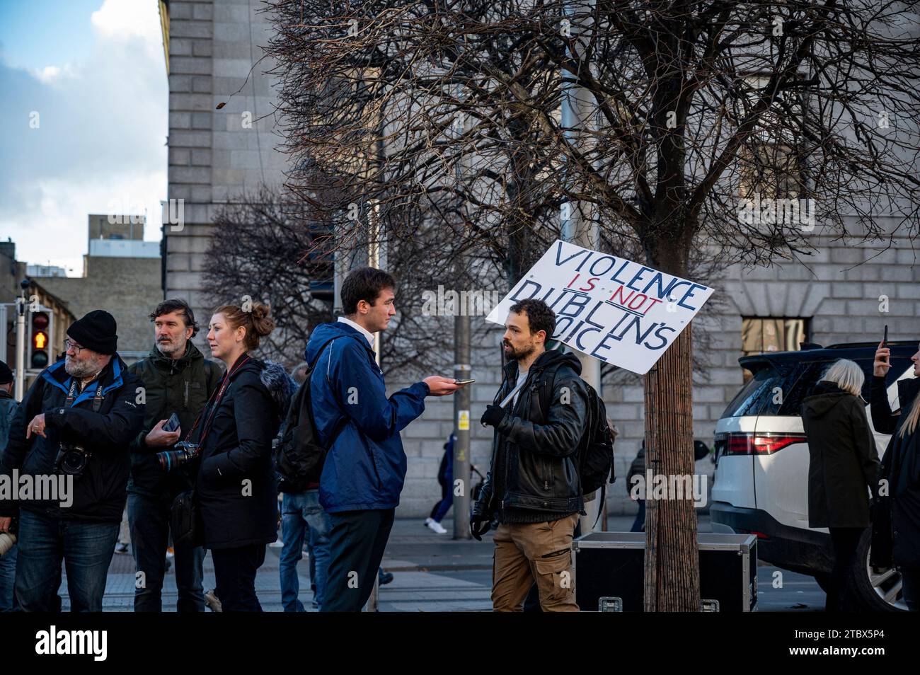 A protester holds a placard reading "Violence is not Dublin's voice as ...