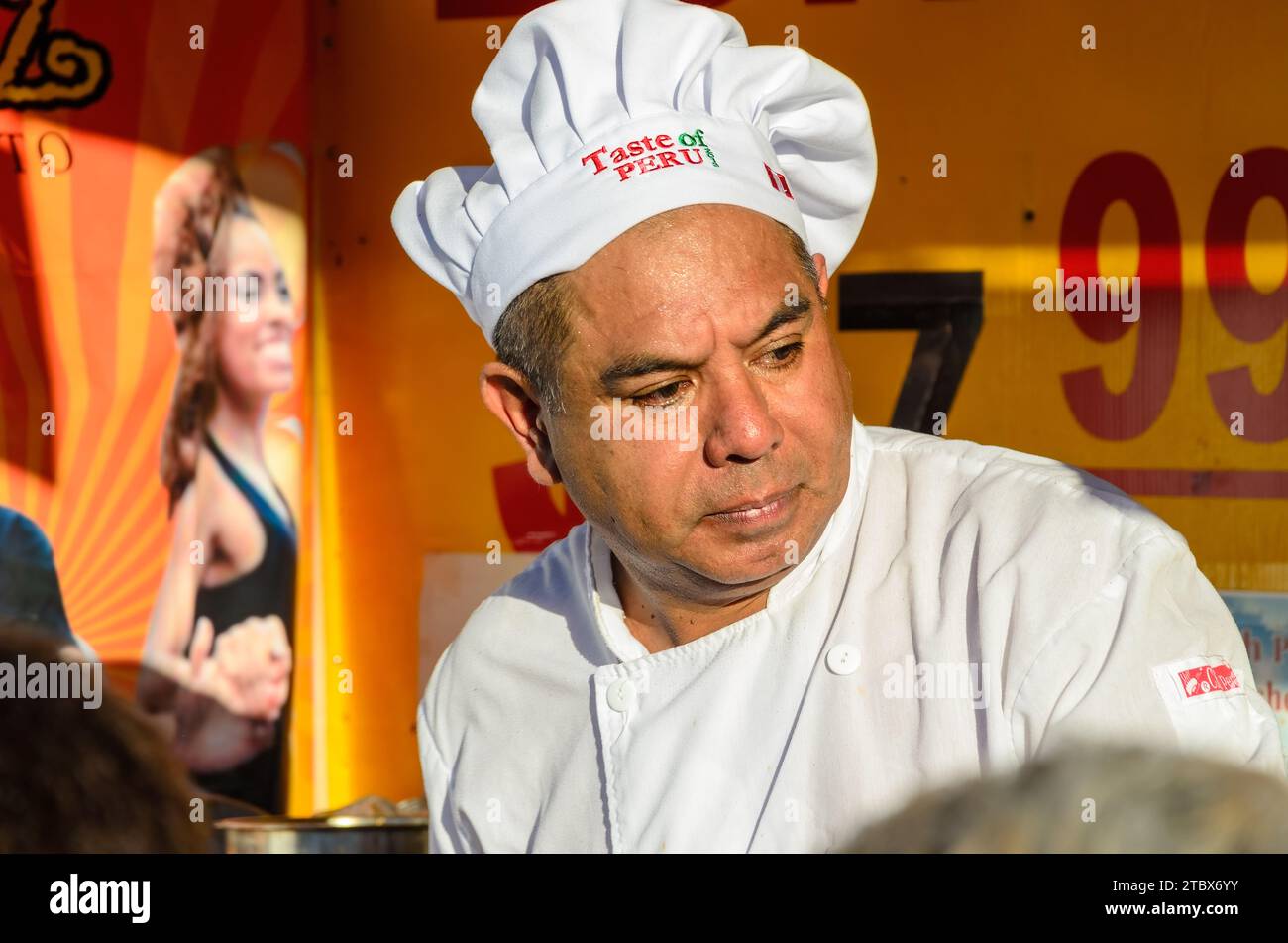 Latin American Chef serving food on a kiosk during Salsa on St. Clair ...