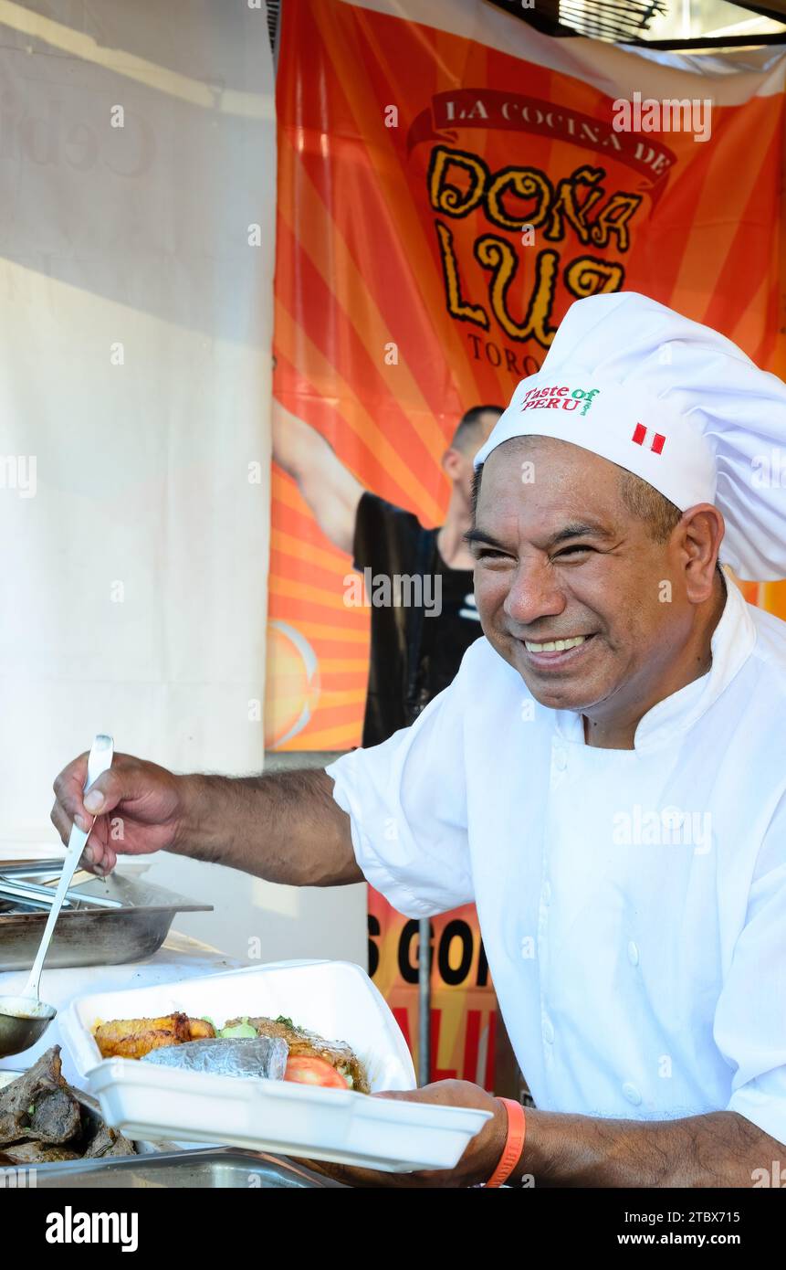 Latin American Chef serving food on a kiosk during Salsa on St. Clair ...