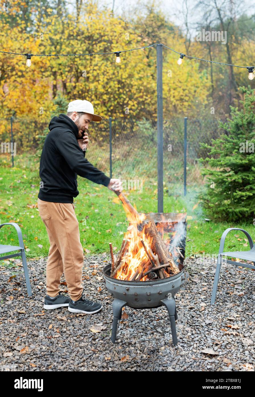 Young man lights fire in hi-res stock photography and images - Alamy