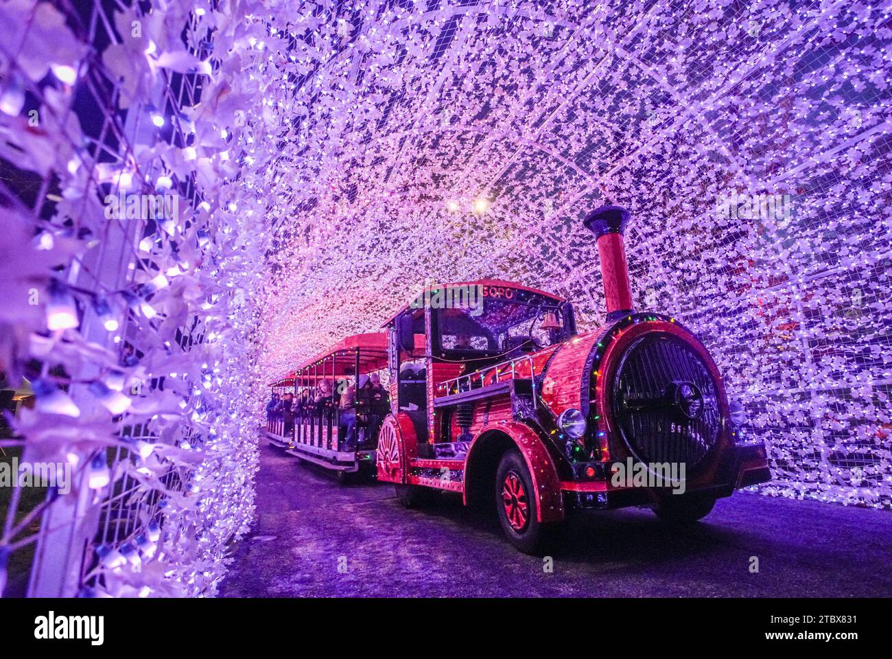 Vancouver, Canada. 8th Dec, 2023. Visitors ride on a train through a ...