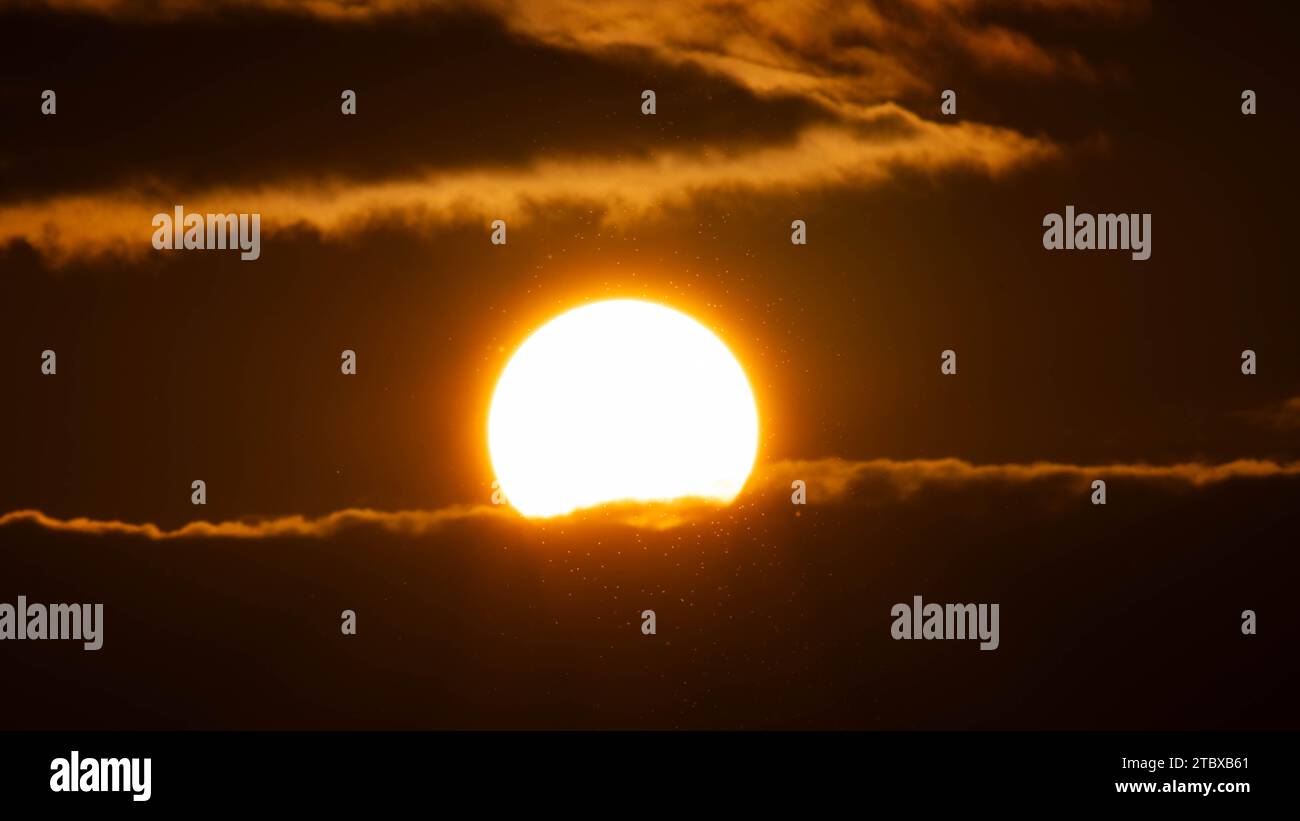 Closeup of bright big sun on the sky with orange gradient colors in a ...