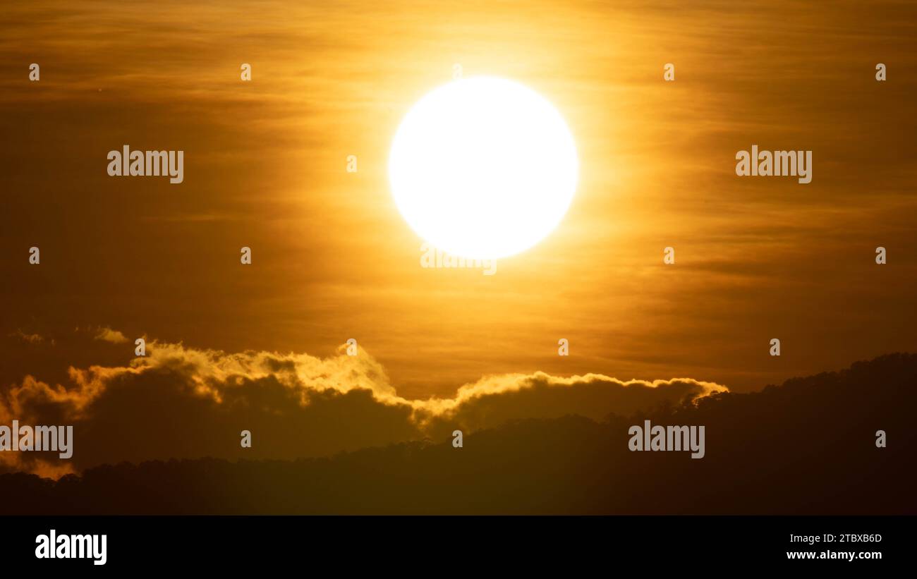 Closeup of bright big sun on the sky with orange gradient colors in a ...