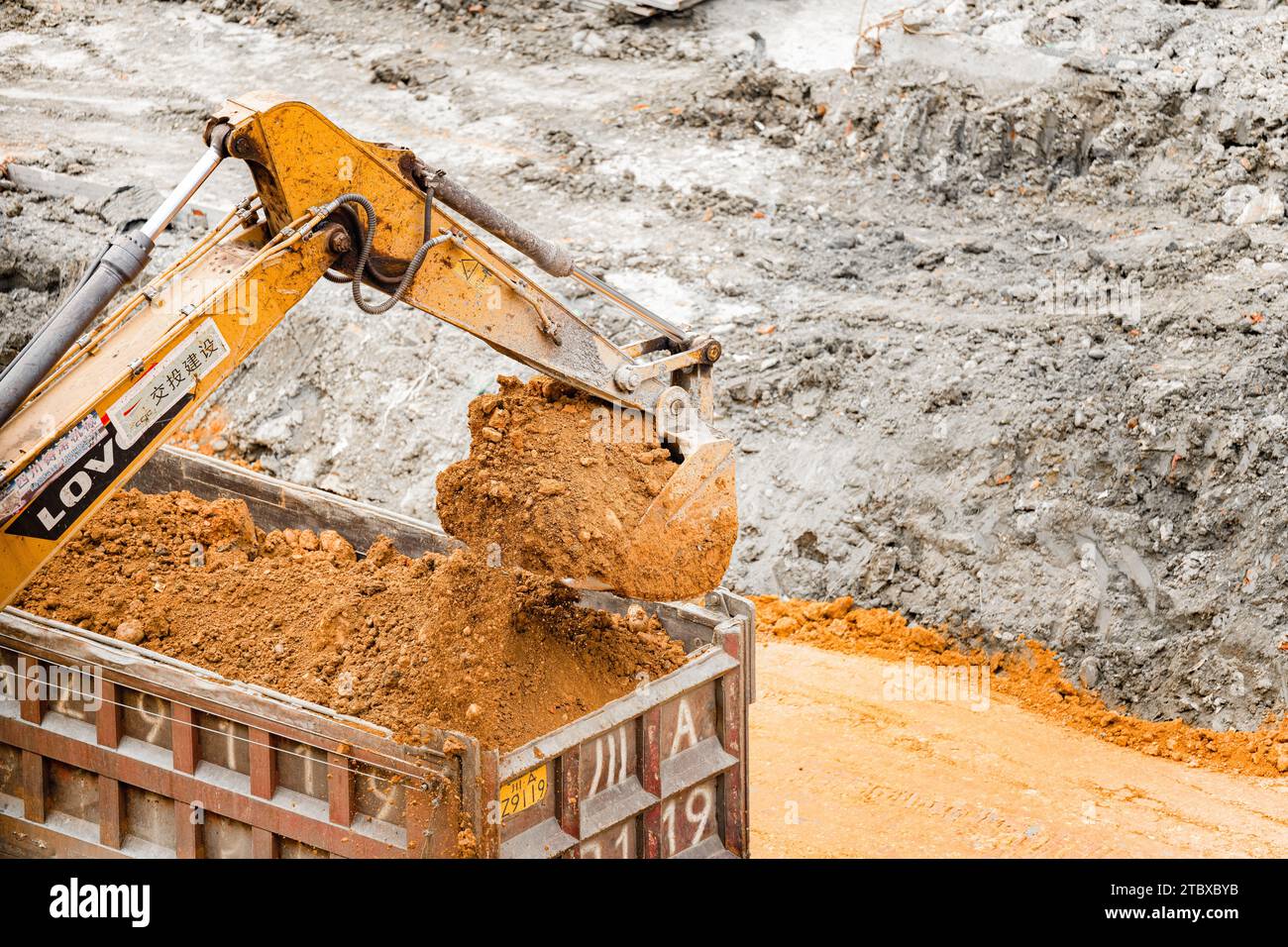 Excavator digging soil inside construction site Stock Photo - Alamy Excavator digging soil inside construction site Stock Photo - Alamy