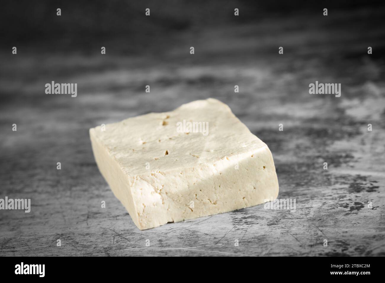 Tofu on plate with black background Stock Photo - Alamy