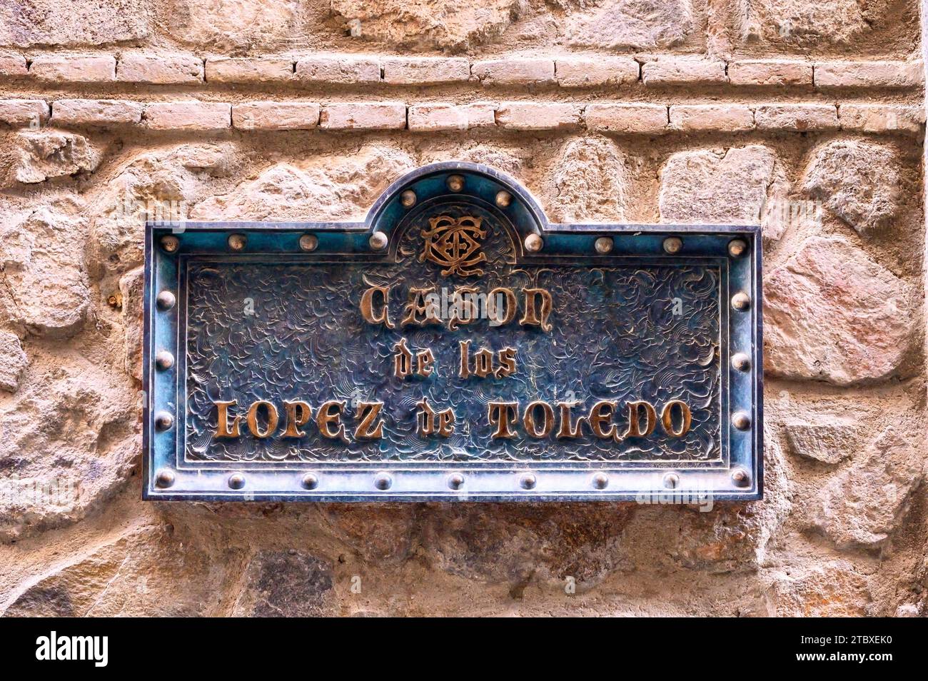 Metallic plaque with text reading Cason de los Lopez de Toledo. The ...