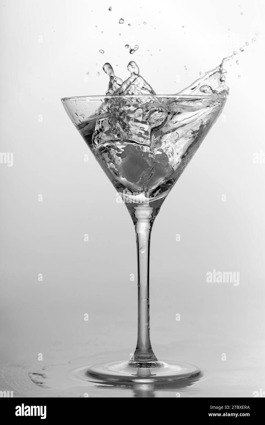 Splash in martini glass, alcohol, frozen motion Stock Photo - Alamy