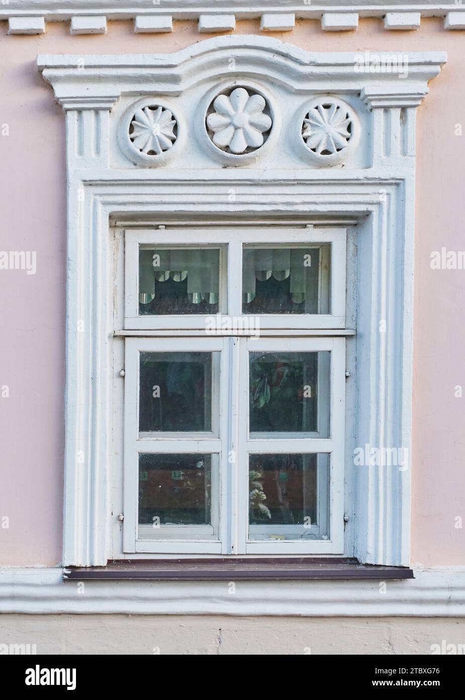 Window with plaster plat bands of historic building of parish school in ...