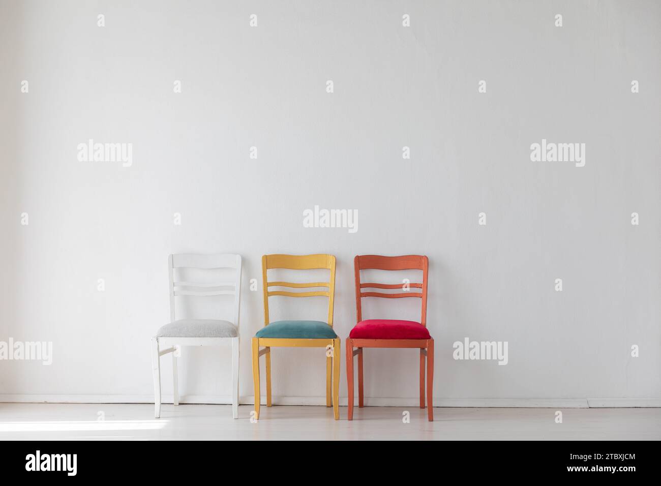 Three old vintage chairs in the interior of a white room Stock Photo - Alamy