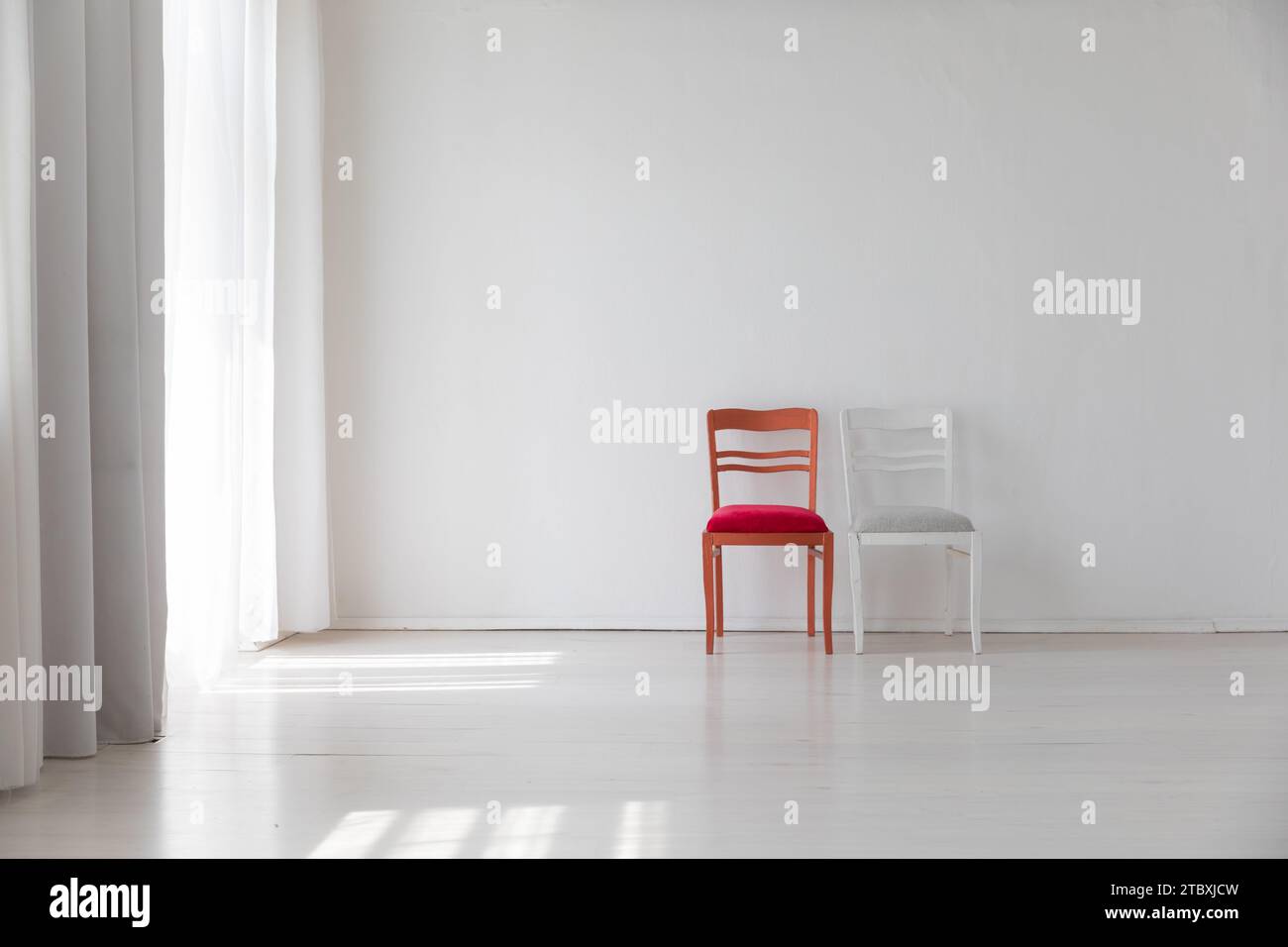 Two old vintage chairs in white room interior Stock Photo - Alamy