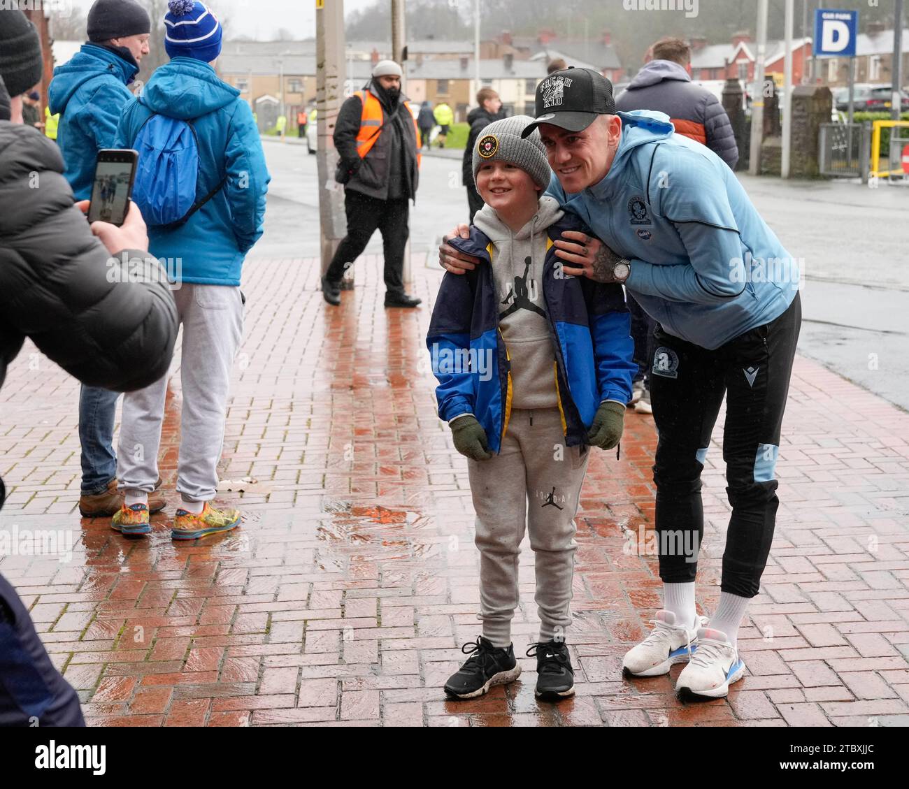 Sammie Szmodics #8 of Blackburn Rovers poses for a photo with a fan as ...