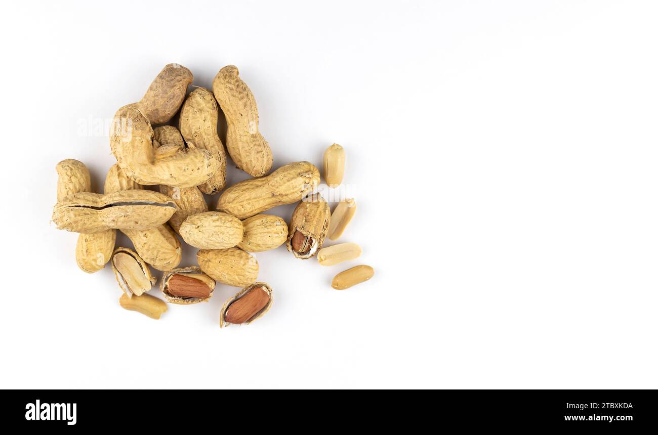 Raw peanuts on a white background, top view. Unshelled peanuts Stock ...