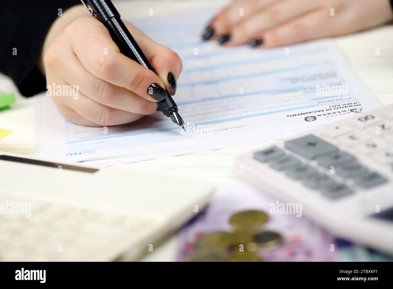 KYIV, UKRAINE - OCTOBER 31, 2023 Accountant fill italian tax form F24 ...