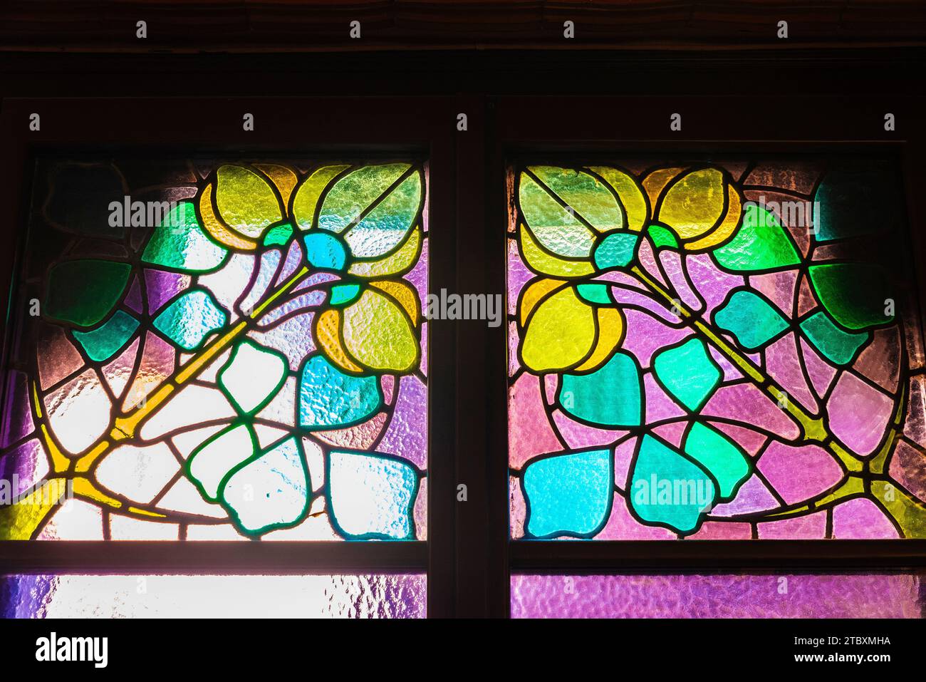 Stained-glass window decorated with floral shapes of the Palau de la ...