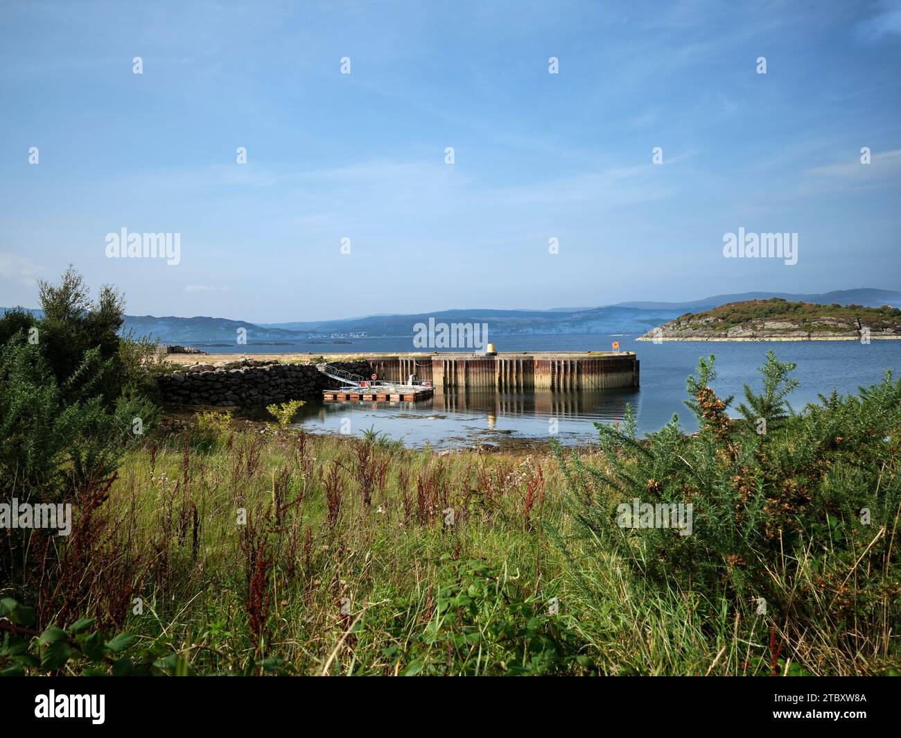 With fish farm enclosures in the distance, the jetty by the Portavadie ...
