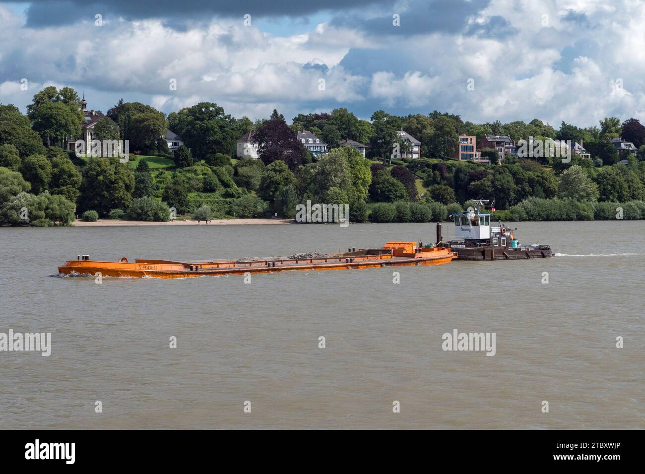A barge being pushed by the Theodor inland tug boat on the River Elbe ...