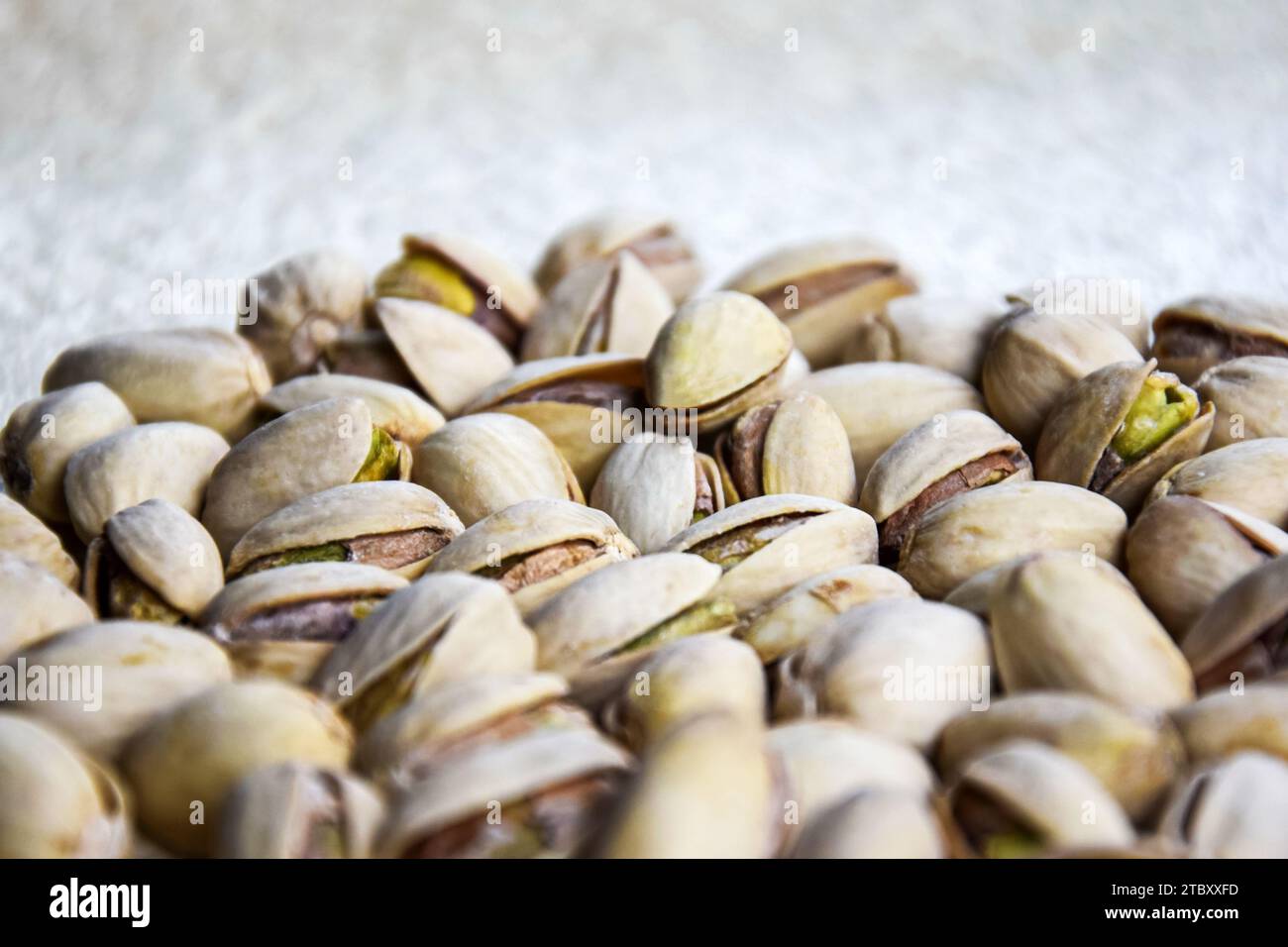 Ripe salt pistachio kernels and pistachios in shell. Healthy eating. Close-up. Copy space ...