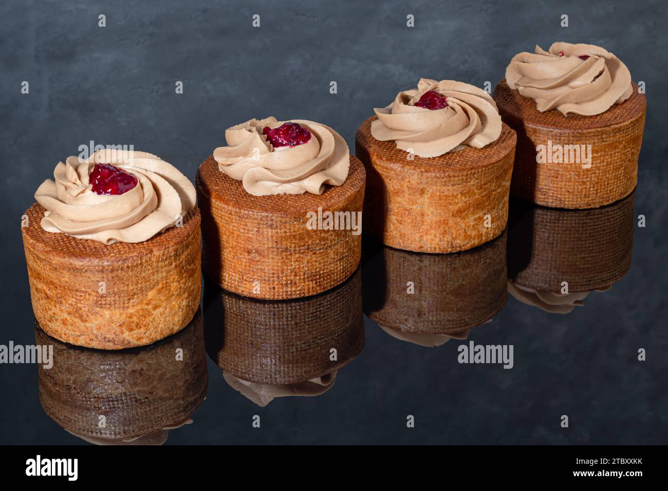 Cakes filled with cream and cherry jam. Box eclairs. New Year and ...