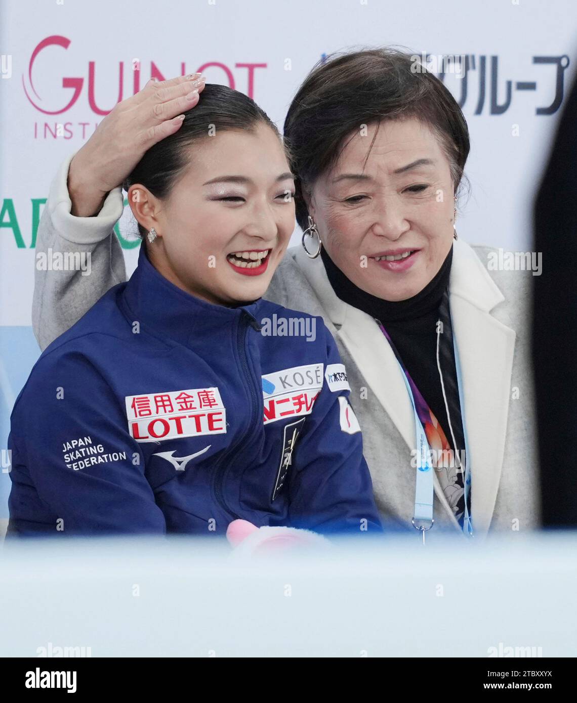 Japan's Kaori Sakamoto (L) smiles after perfoming the women's free ...