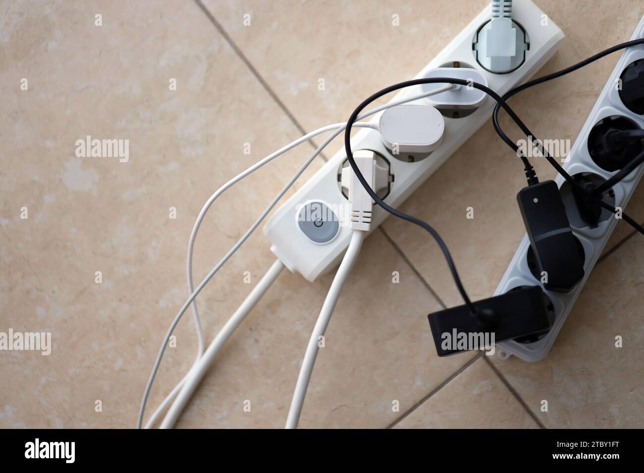 Overloaded power boards. Power strips with different electrical plugs ...