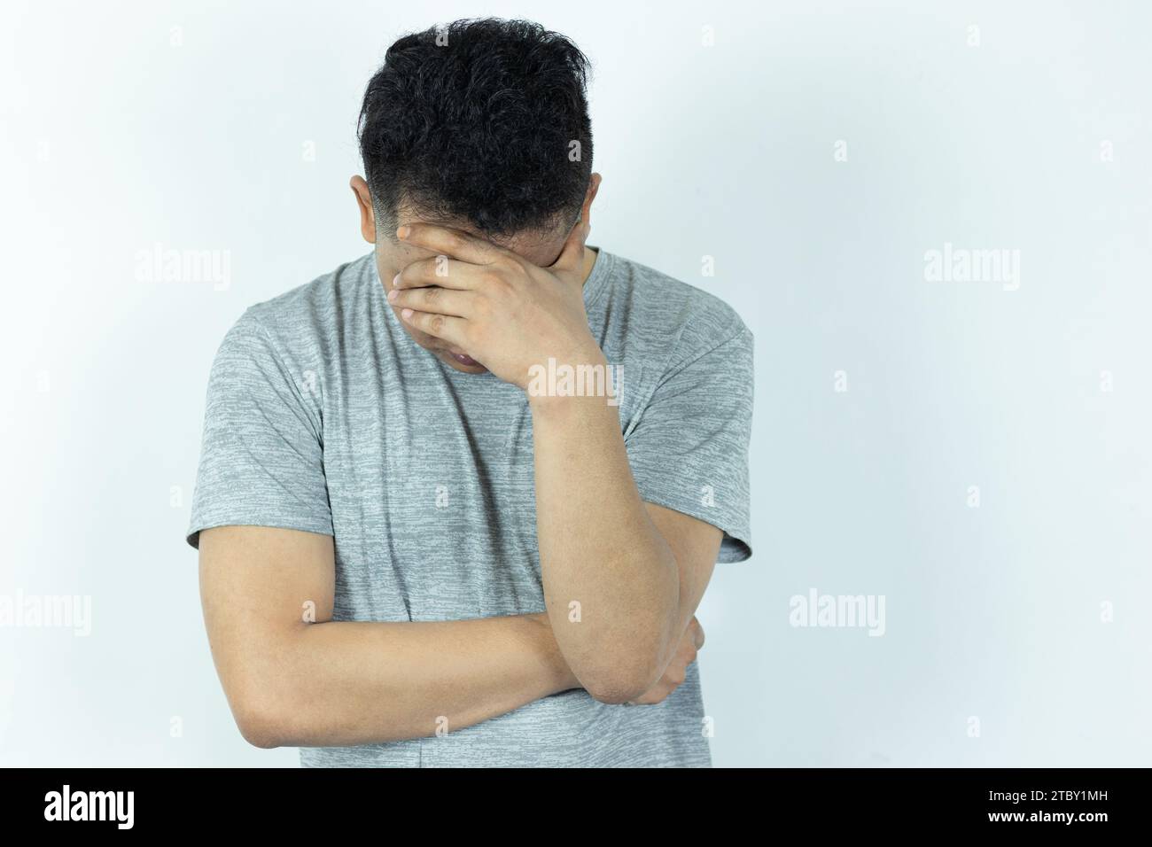 Portrait of Depressed Asian Man hiding his face with hands. Stressed ...