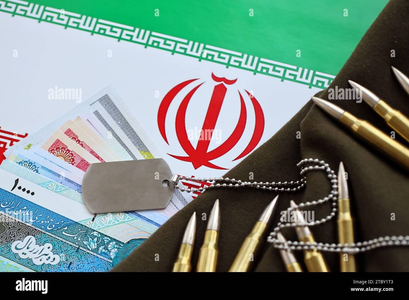 Many bullets and iranian rials money bills on flag of Islamic Republic ...