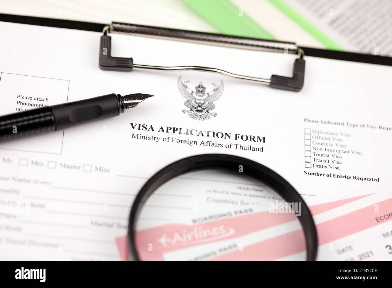 Thailand Visa application form on A4 tablet lies on office table with ...