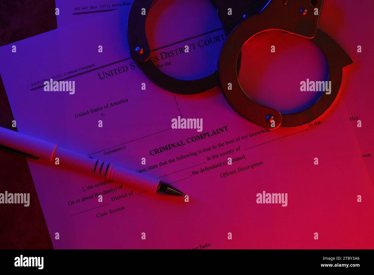 District Court Criminal complaint court papers with handcuffs and blue ...