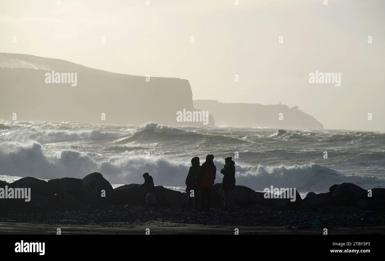 People watching high waves in Doolin in County Clare on the west coast ...