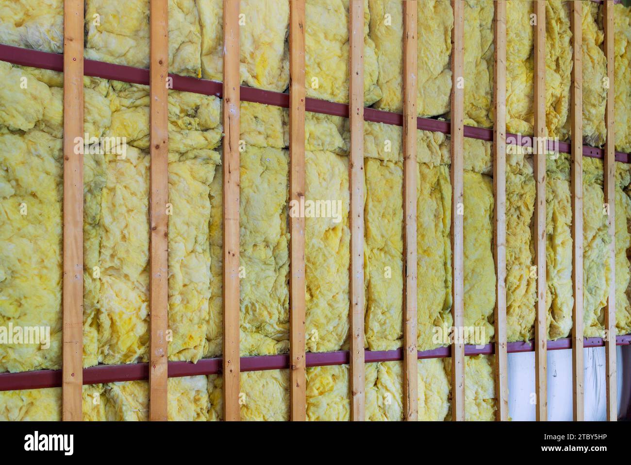 Installation of mineral rock wool insulation in new home that has been ...