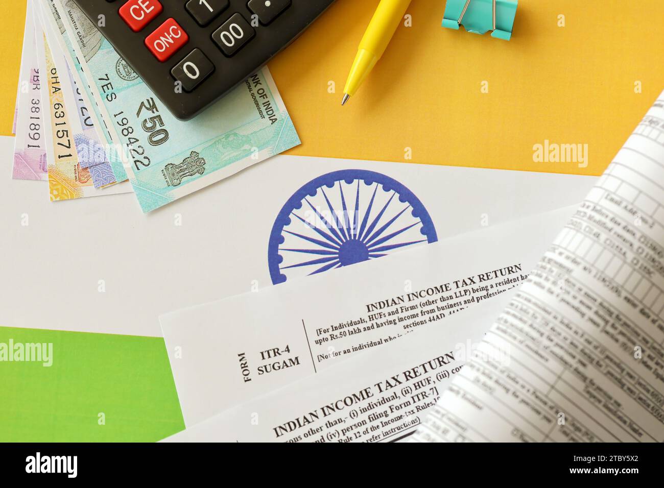 Indian income tax return blank form with pen and indian rupees bills on ...