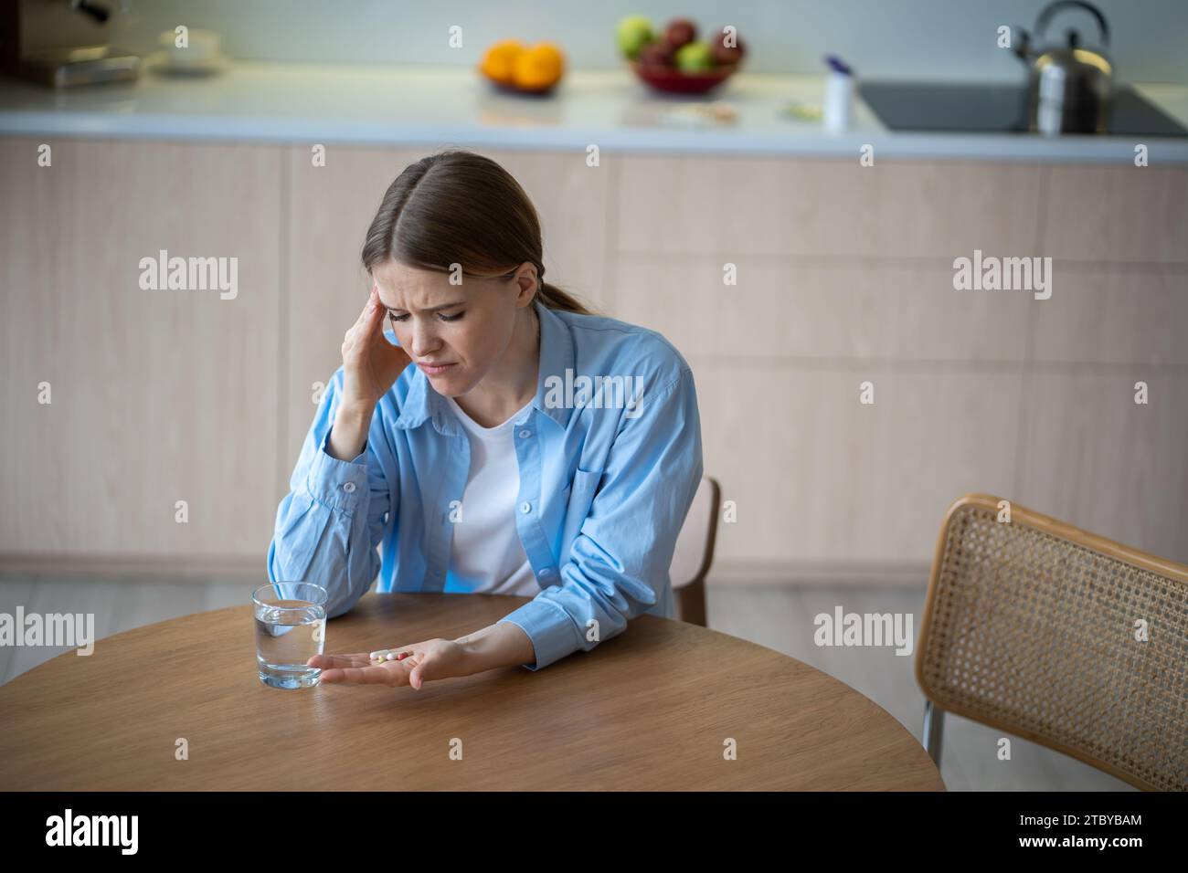 Sick woman with frowning face and closed eyes, touching head, having ...