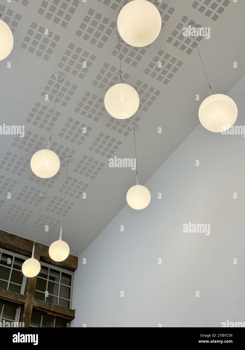 Ball lights hanging from ceiling in new office reception Stock Photo ...