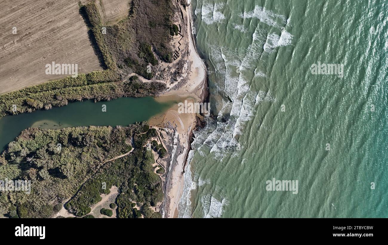 Aerial view of an island surrounded by an expanse of blue water, with ...