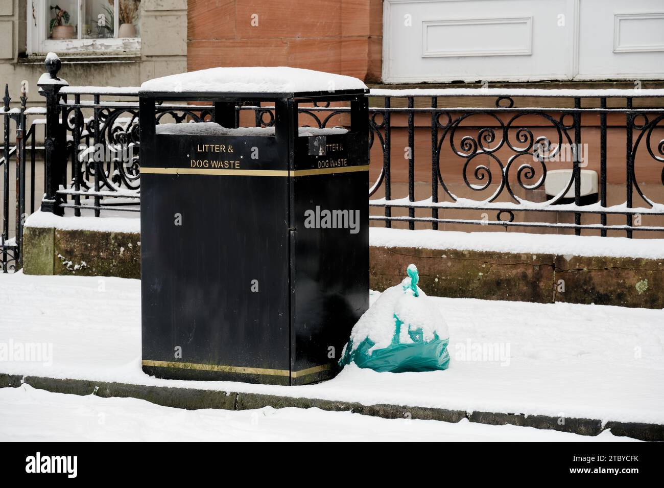 Black litter bin for rubbish collection during the winter Stock Photo ...