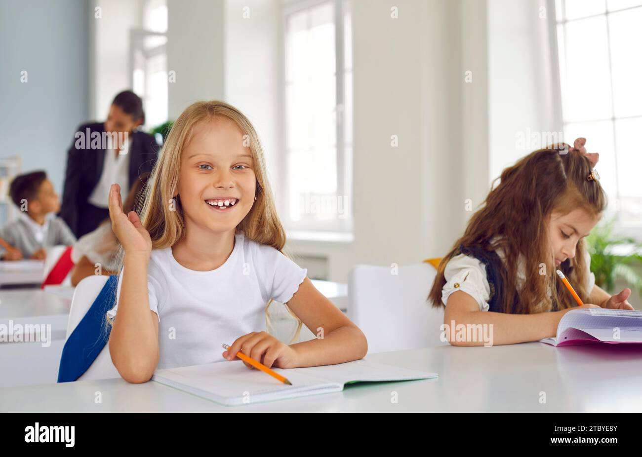 Happy cute school children in classroom at lesson Stock Photo - Alamy