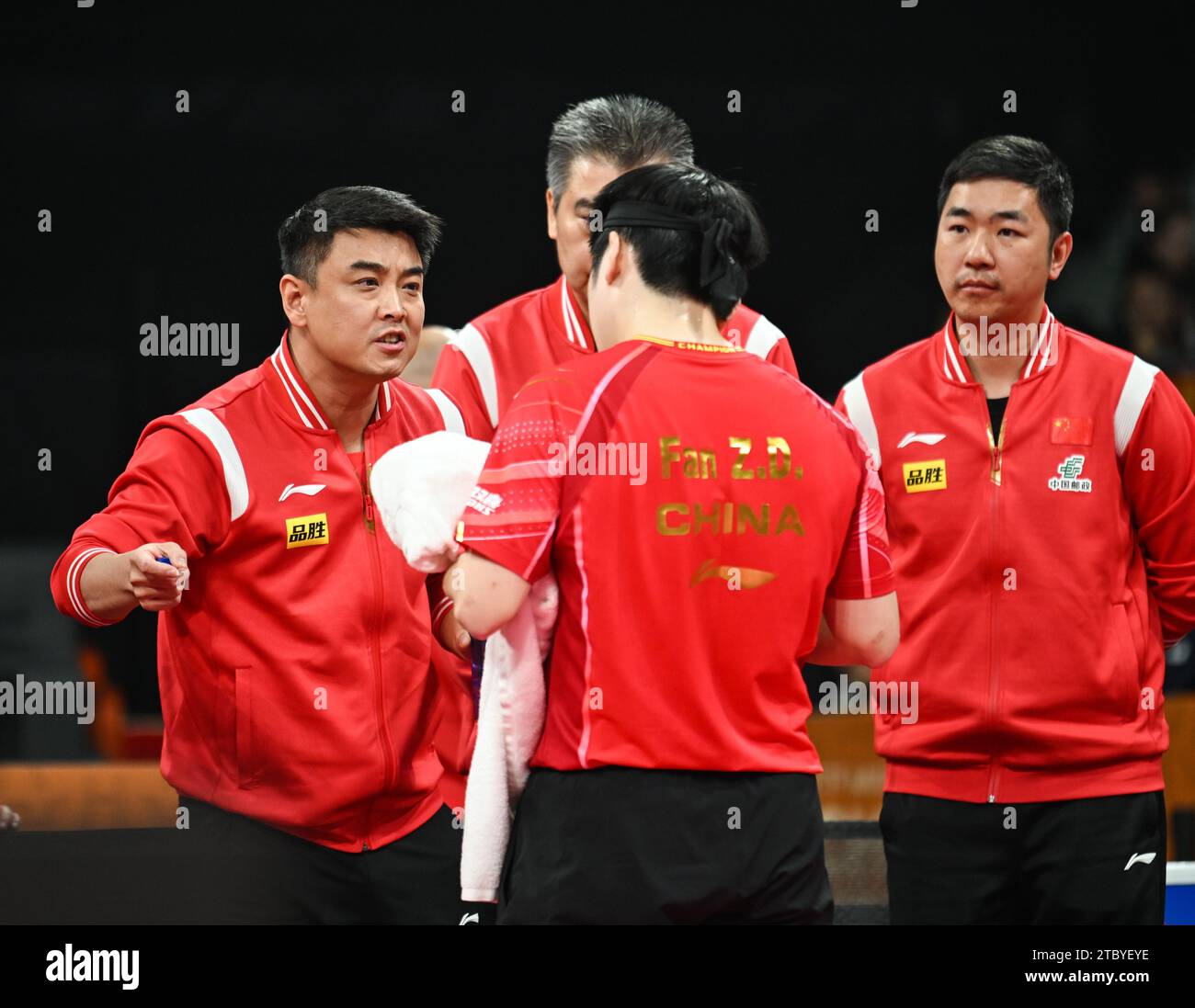 Chengdu, China's Sichuan Province. 9th Dec, 2023. China's coach Wang Hao (1st L) instructs Fan ...