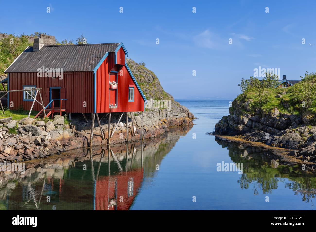 A classic red wooden house on the shores of the Lofoten Islands, Norway ...