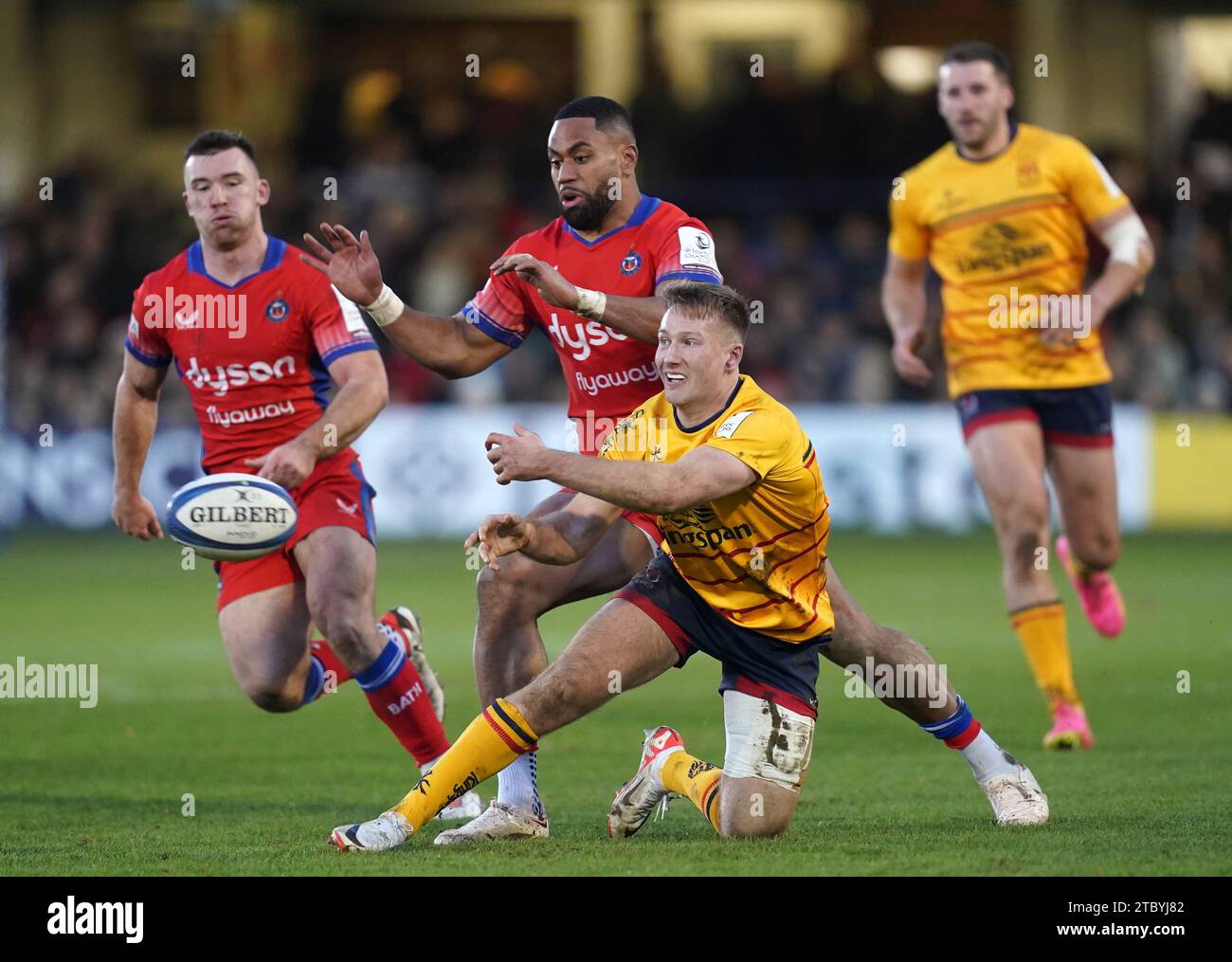 Ulster Rugby's Stewart Moore offloads the ball past Bath Rugby's Joe ...
